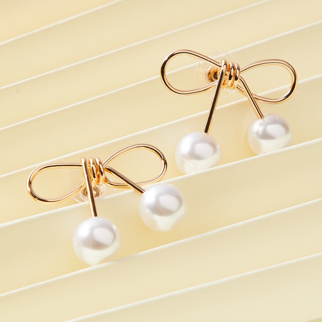 Buy GINGER Bow Shaped Pearl Studs from Ginger at just INR 199.0