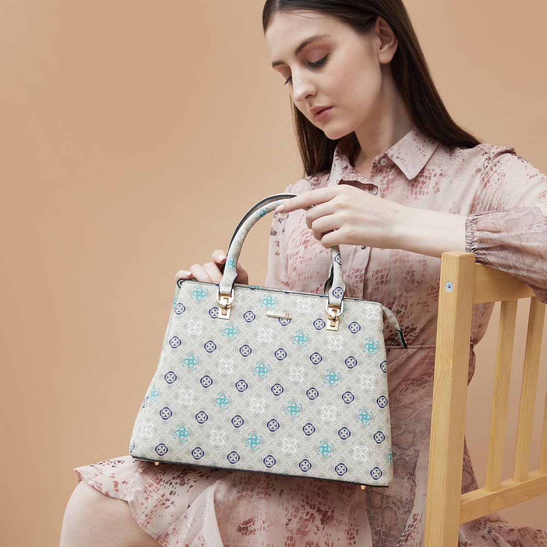 Buy CODE Monogram Print Handheld Bag from CODE at just INR 2899.0